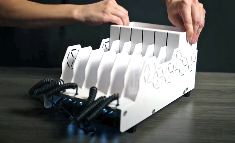 How does the backstop/cable compartment work on the Open charging station?